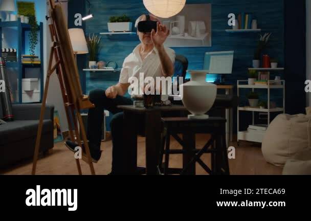 Retired man using vr glasses with virtual augmented reality to draw ...