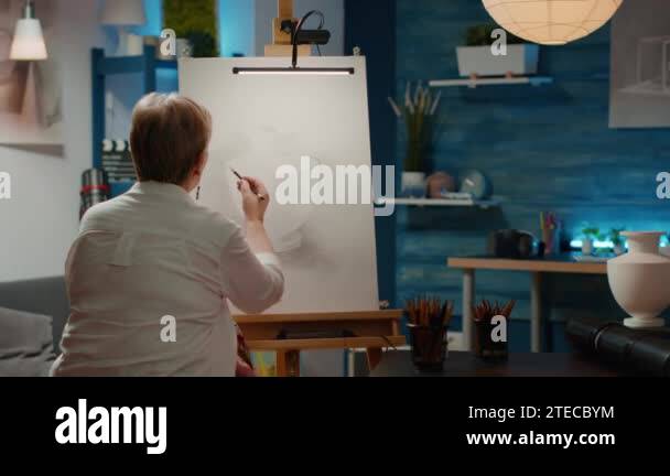 Old person with artistic skills drawing professional sketch of vase ...