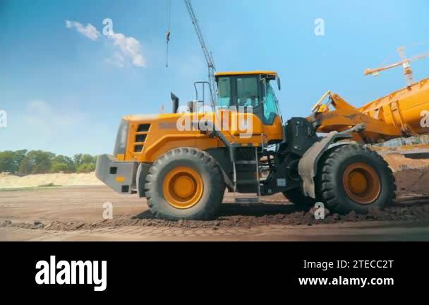 Modern tractor on a construction site. Large yellow tractor ...