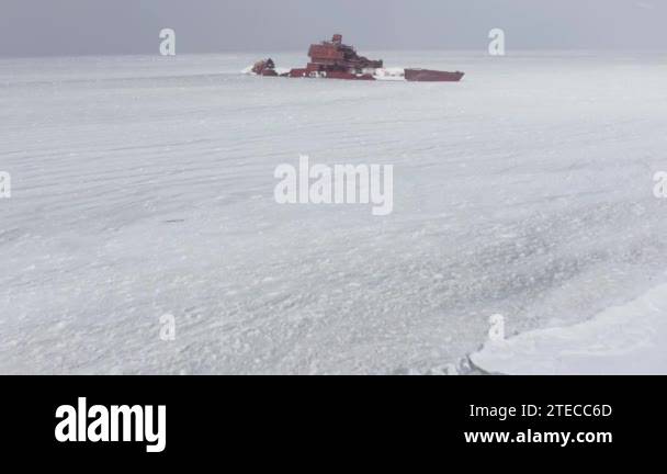 A cargo ship was thrown ashore during a sea storm. In winter, a large ...