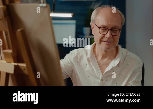 Retired man using artistic technique and pencils to draw masterpiece ...