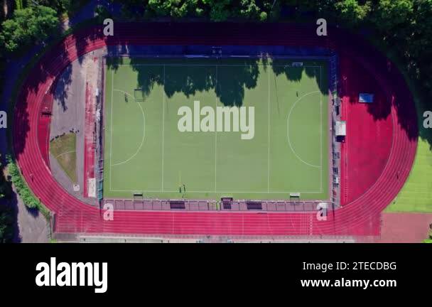 Buildings with street in small town with empty football soccer field ...