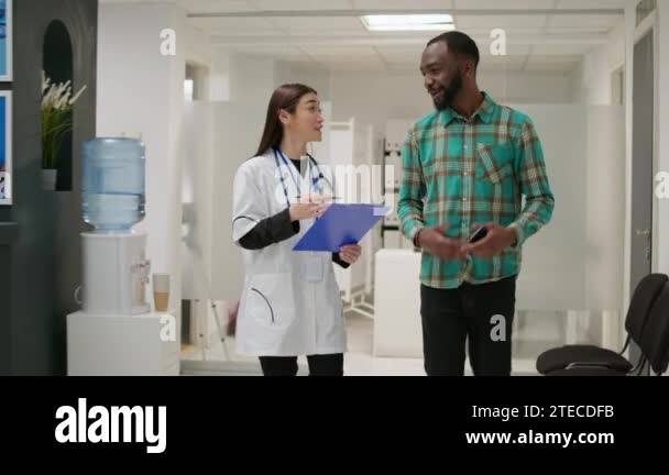 Medical assistant explaining x ray scan results to african american ...