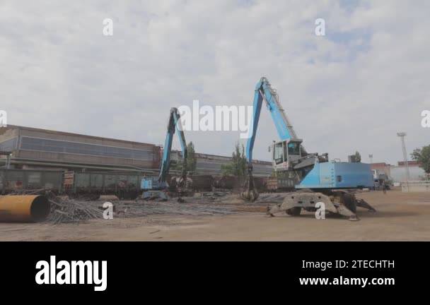 Recycling of metal. Excavator with grab. Recycling metal waste, metal ...