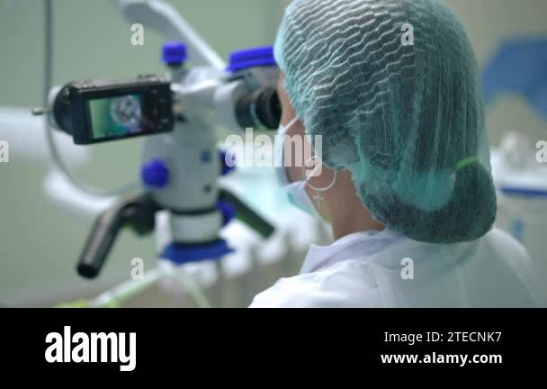 Shooting over shoulder of professional orthodontist using dental ...