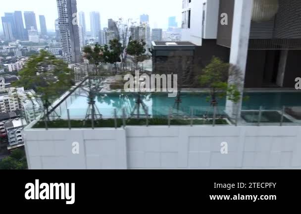 Migrant Sitting On A Luxurious Hotel Rooftop With Sight Of Urban ...