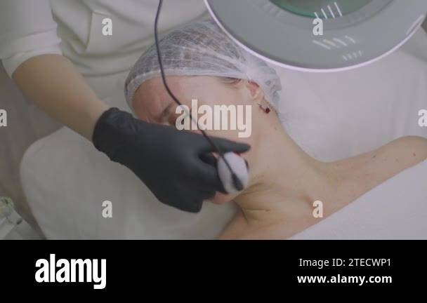 Close-up of a woman face. Needle mesotherapy procedure into the skin of ...