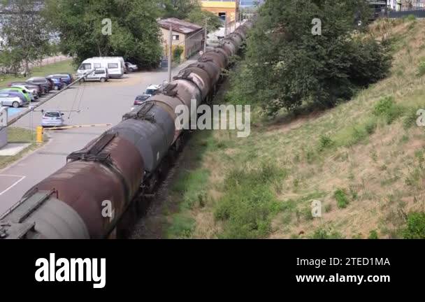 Moving train with liquid chemical transportation cars slowly going next ...