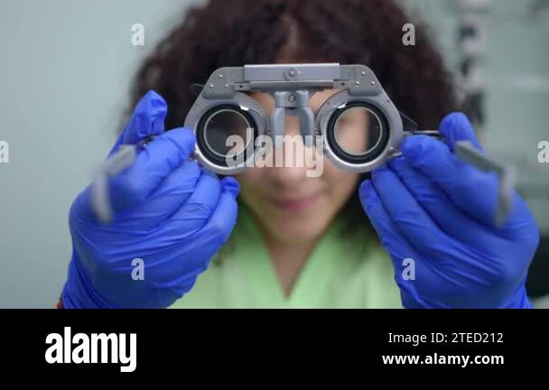 Patient POV of blurred doctor putting on lens frame close-up. Caucasian ...