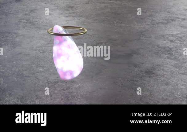 Soft liquid sphere falling through a golden ring and bouncing along the floor. 3d animation ...