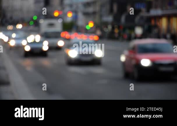 Defocused receding city traffic in the evening. Out of focus lights of ...