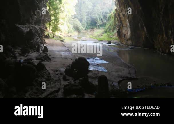 Woman exploring cavern, cave exploration. Traveler explorer walk in ...