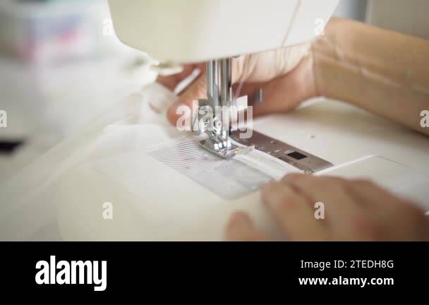 Man sews at a sewing machine. Dressmaker working. Concept of clothing ...