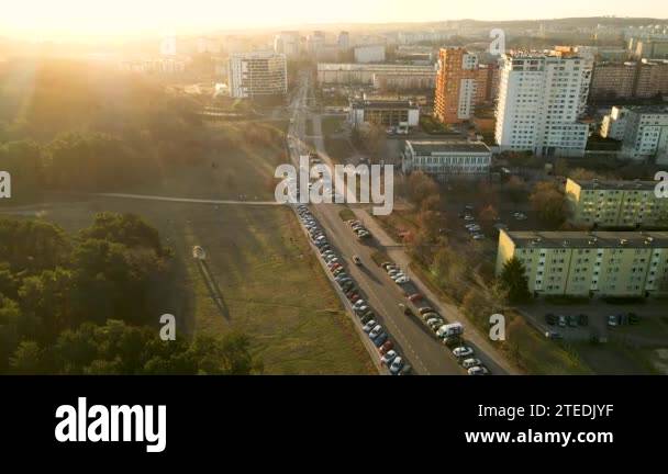 Multiple cars driving over a main road between parked cars with in the ...