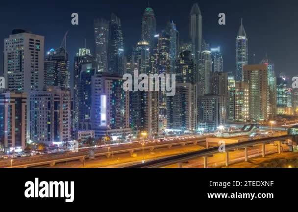 Dubai marina tallest block of skyscrapers night timelapse. Aerial view ...