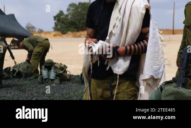 A Jewish religious soldier prays at a military base in the middle of ...