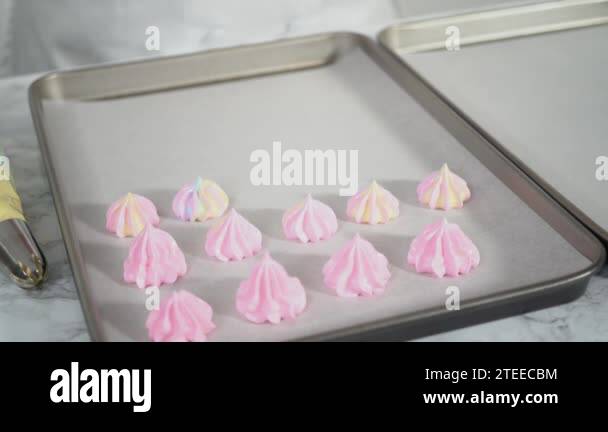 Step by step. Piping unicorn meringue cookies to the baking sheet lined with a parchment paper ...