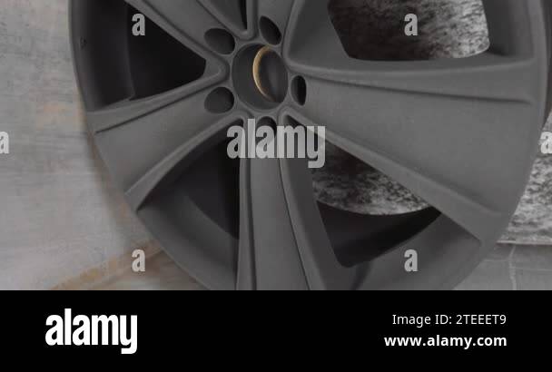 Close up of aluminium wheel with new powdercoat applied before curing ...