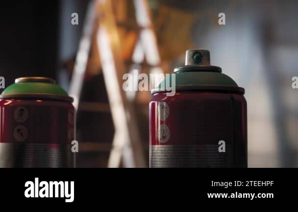 Isolated spray paints ready for street art, with blurry people on the ...