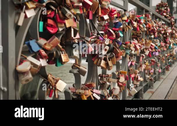 Iron locks of newlyweds hanging on bridge. Bridge of love. Tradition ...