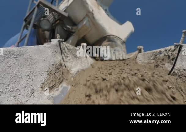 Logistics at the construction site - concrete mixer unloads liquid ...