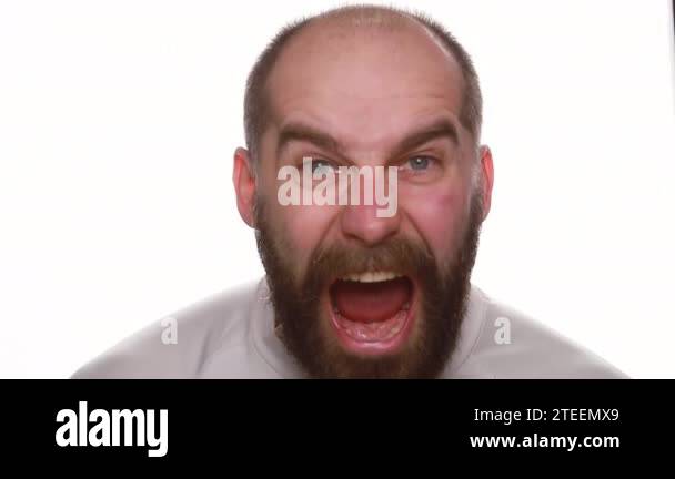 Portrait of angry man screaming in studio. Rage guy shouting on white ...