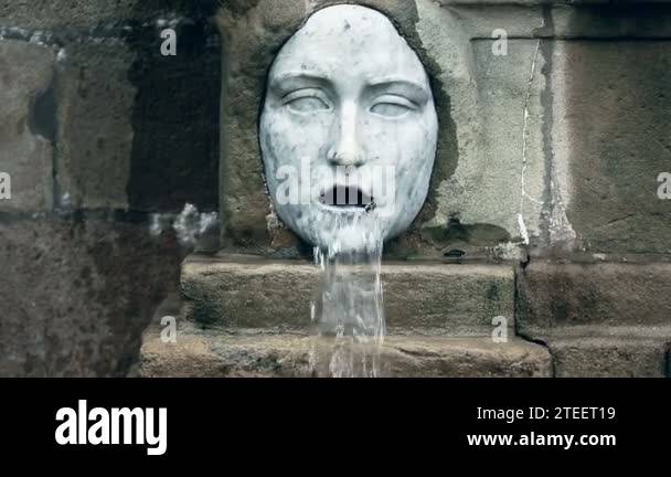 Horizontal pan of two marble fountain sculptures with horrifying ...