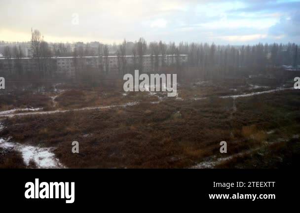 Winter weather outside the window. It is snowing and raining. Blizzard ...