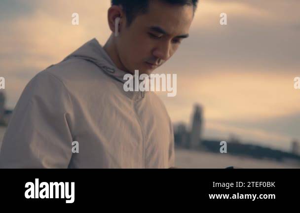 A Handsome athlete runner using smartphone checking internet ...