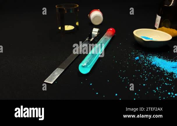 Lab footage, experiments with blue reagents, heating test tubes and ...