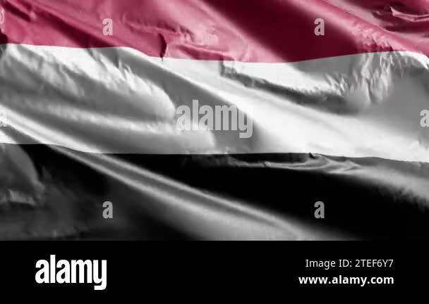 Yemen textile flag waving on the wind loop. Yemen banner swaying on the ...