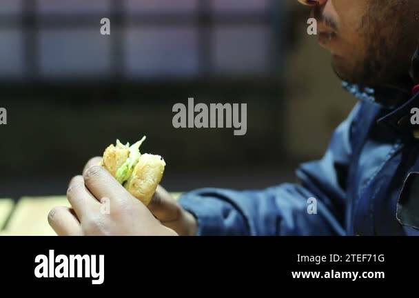 Man stuffing himself with poor quality food, suffering from bad eating ...