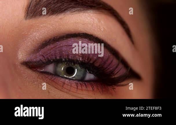 Human eye with fancy arrow make-up. Glitter shadows and false lashes ...