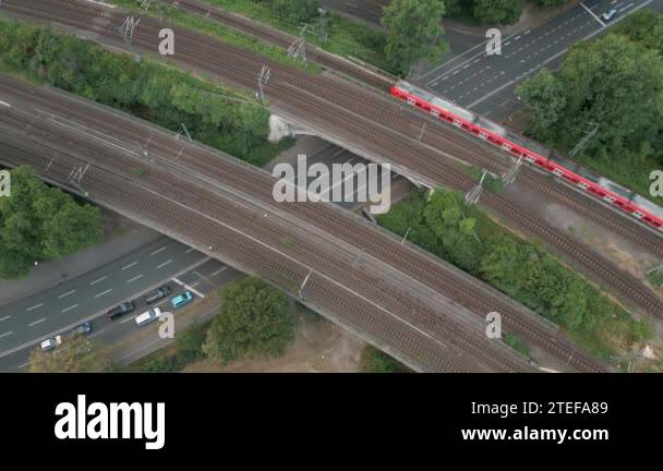 Birds eye view of a railway bridge crossing a big street with a red ...
