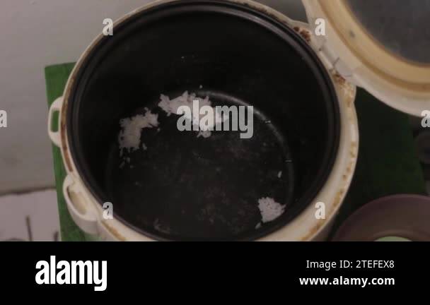 A Man Opening Empty Rice Cooker (a Man opens the rice cooker and sees ...