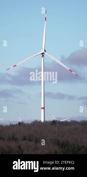 wind energy generator with other towers in background, vertical format ...