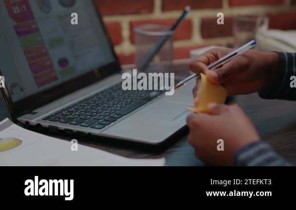 Employee putting sticky notes on laptop screen as work reminder Stock ...