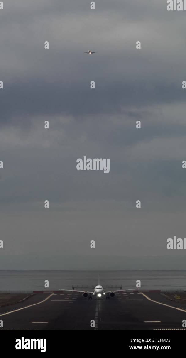 Vertical video - a passenger plane picks up speed, accelerating on a ...