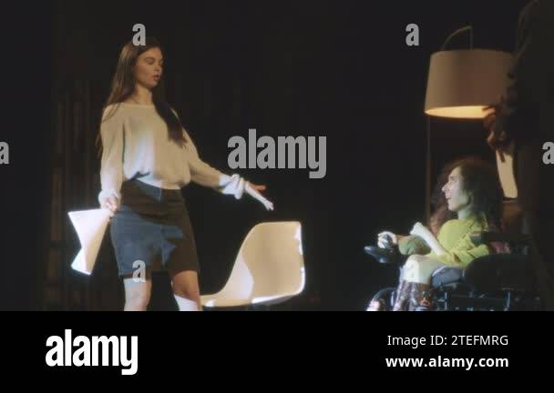 Theater actors with a disabled actress in a wheelchair with scripts ...