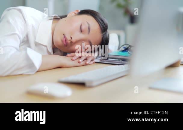 exhausted asian business woman office worker or clerk sleeping at work ...