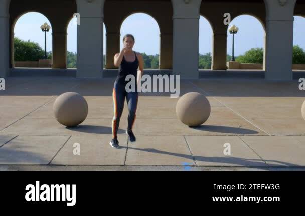 Fit millennial girl dances and gets her groove on in front of arches in ...