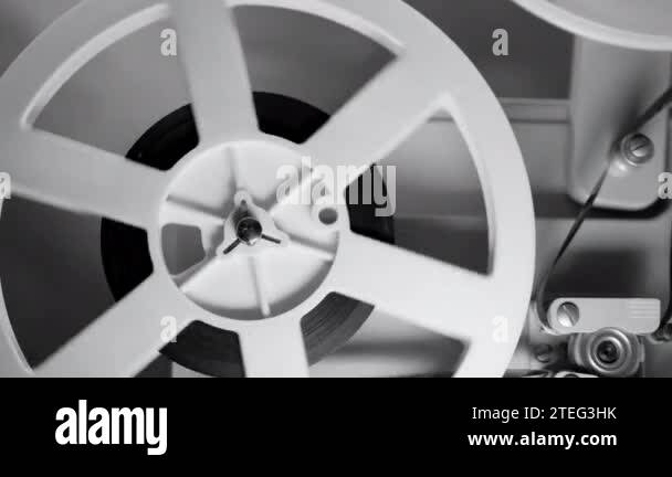 Monochrome footage of film bobbin rotating. Analog player. Retro old ...