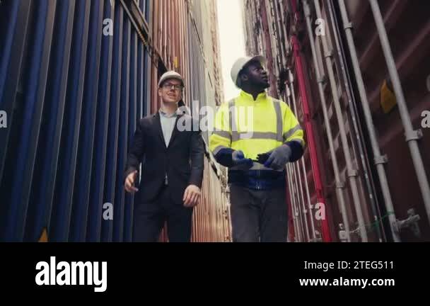 Low level angle of Foreman and inspector checking container box for ...