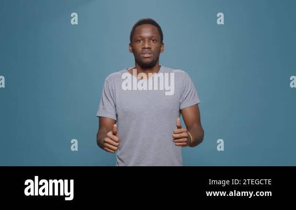 Disappointed person showing thumbs down symbol in studio, doing ...