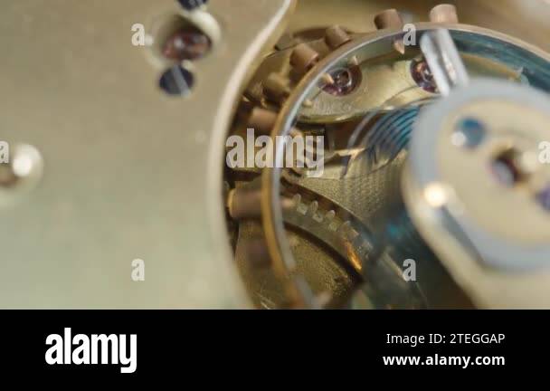 Moving gold gears inside working pocket watch mechanism. Working clock ...