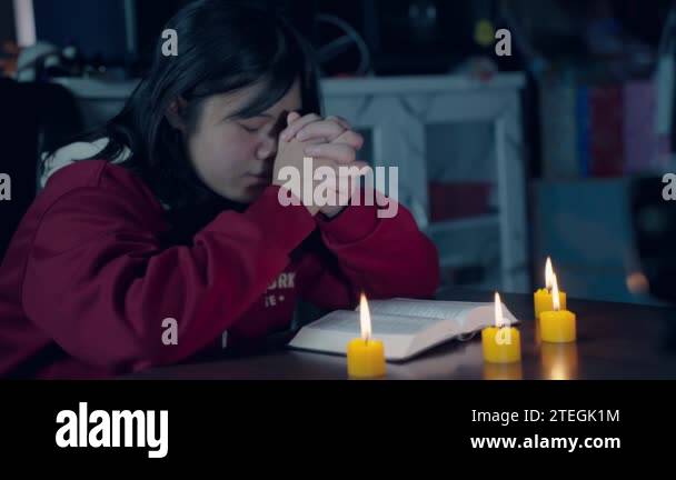 UHD 4k Slow motion B roll of young christian while praying and worship ...