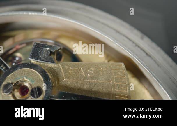 Moving gold gears inside working pocket watch mechanism. Working clock ...