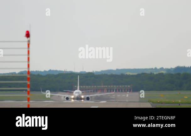 Commercial aircraft picks up speed and takes off, view from the end of ...