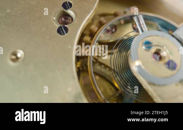 Moving gold gears inside working pocket watch mechanism. Working clock ...