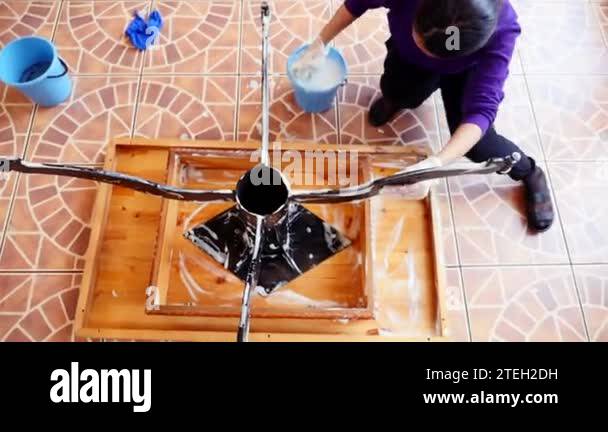 top view Young asian woman using a rag removing dust from the table ...